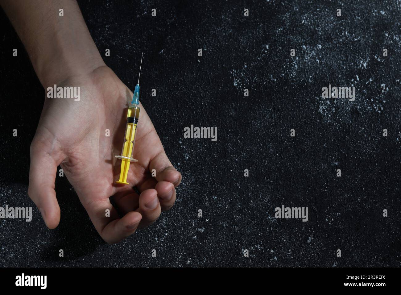 Drug addiction. Man with syringe on black textured table, top view and ...