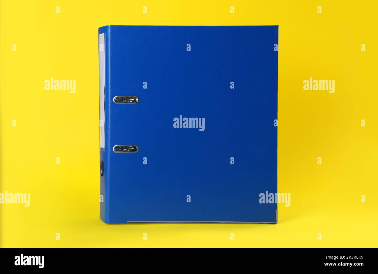Blue hardcover office folder on yellow background Stock Photo - Alamy