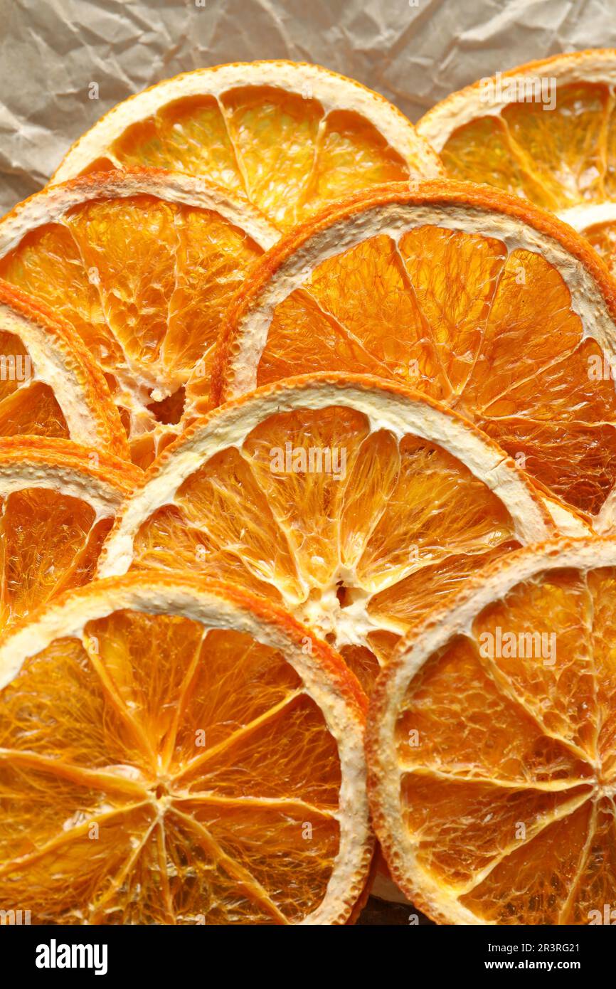 Many dry orange slices on parchment paper, closeup Stock Photo - Alamy