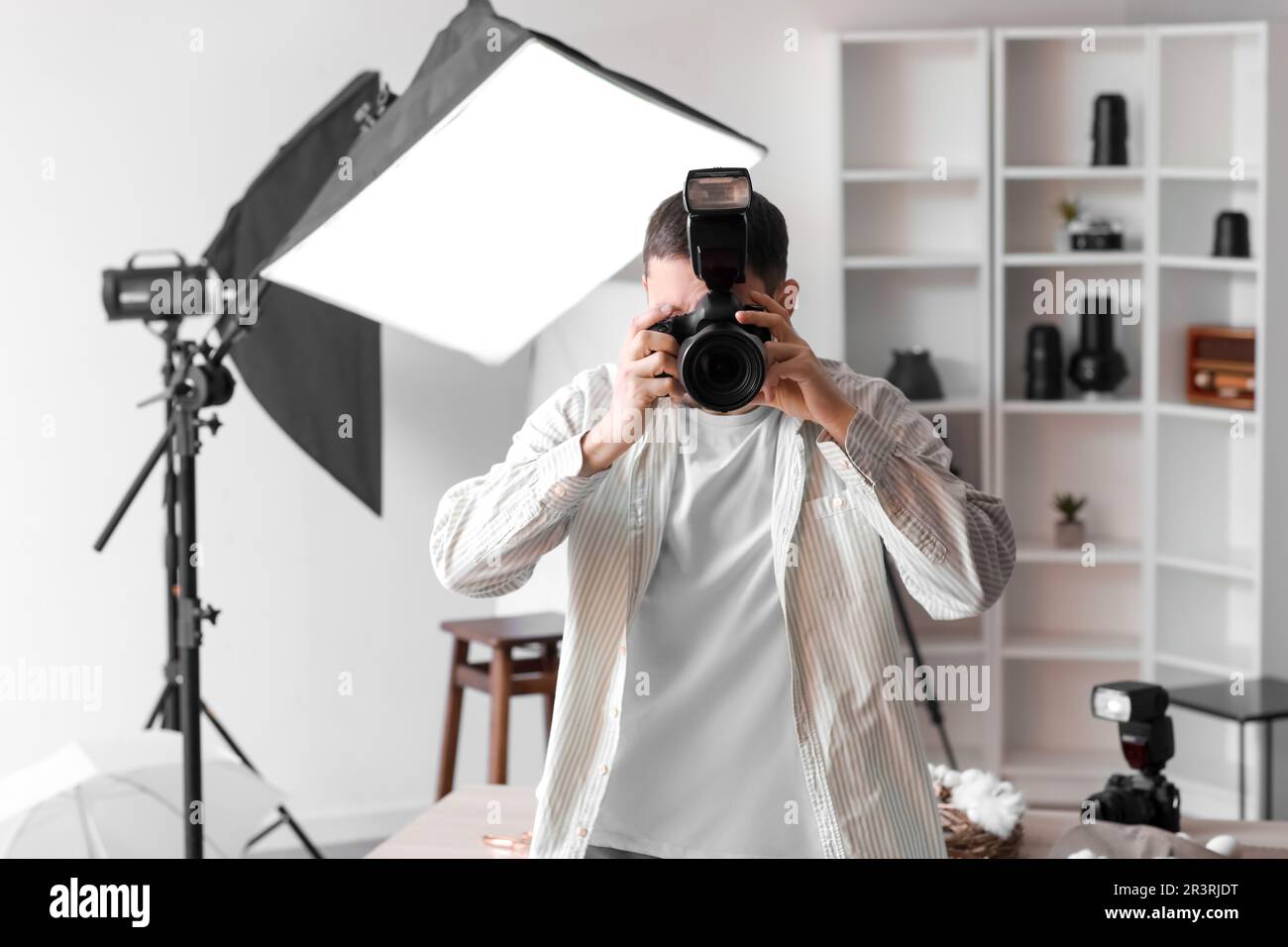 Handsome photographer with professional camera in studio Stock Photo ...