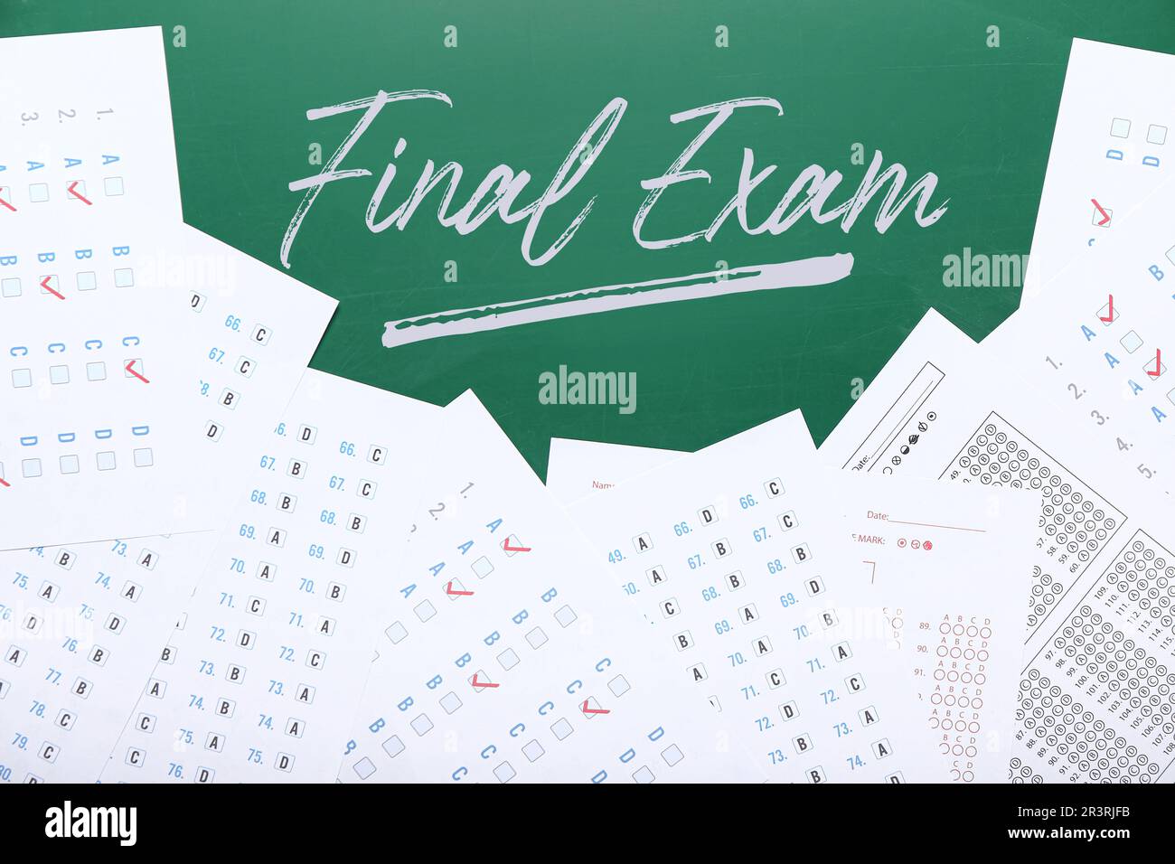 Answer sheets and text FINAL EXAM written on chalkboard Stock Photo - Alamy