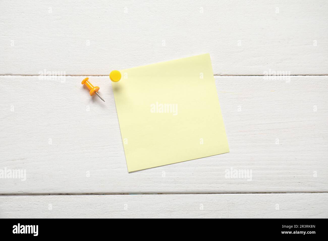Sticky notes with pins on white wooden background Stock Photo - Alamy