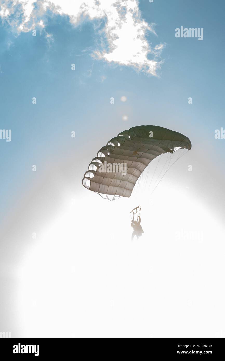 A special operations forces soldier glides toward a drop zone (DZ ...