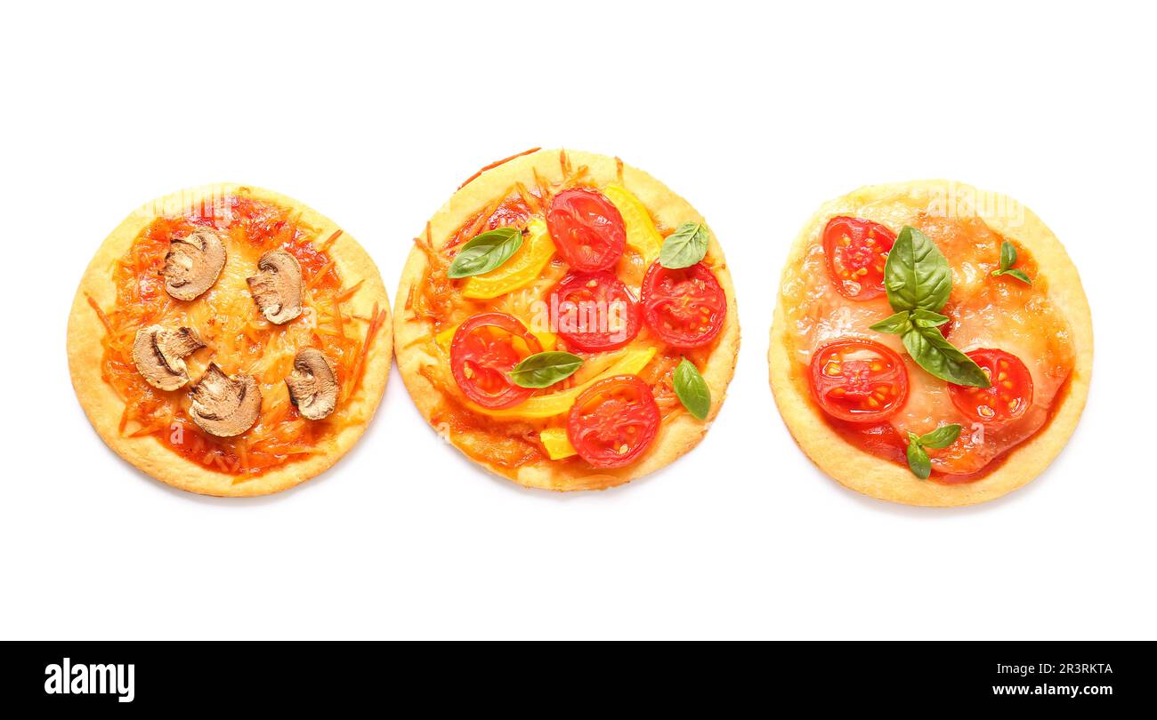 Different tasty mini pizzas on white background Stock Photo - Alamy