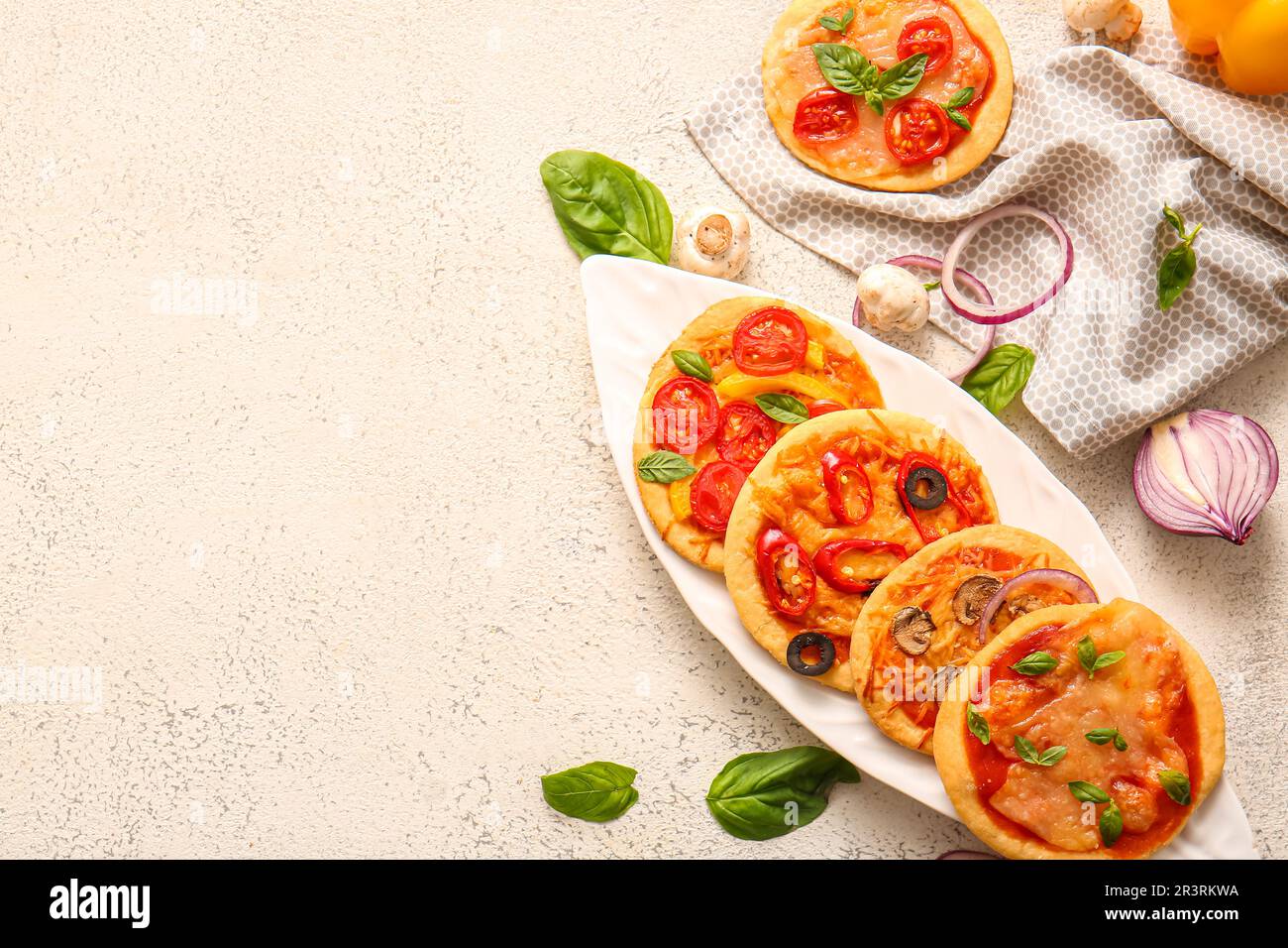 Plate with different tasty mini pizzas on white background Stock Photo ...