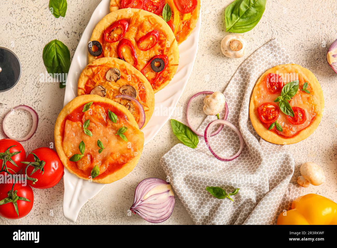 Plate with different tasty mini pizzas on white background Stock Photo ...