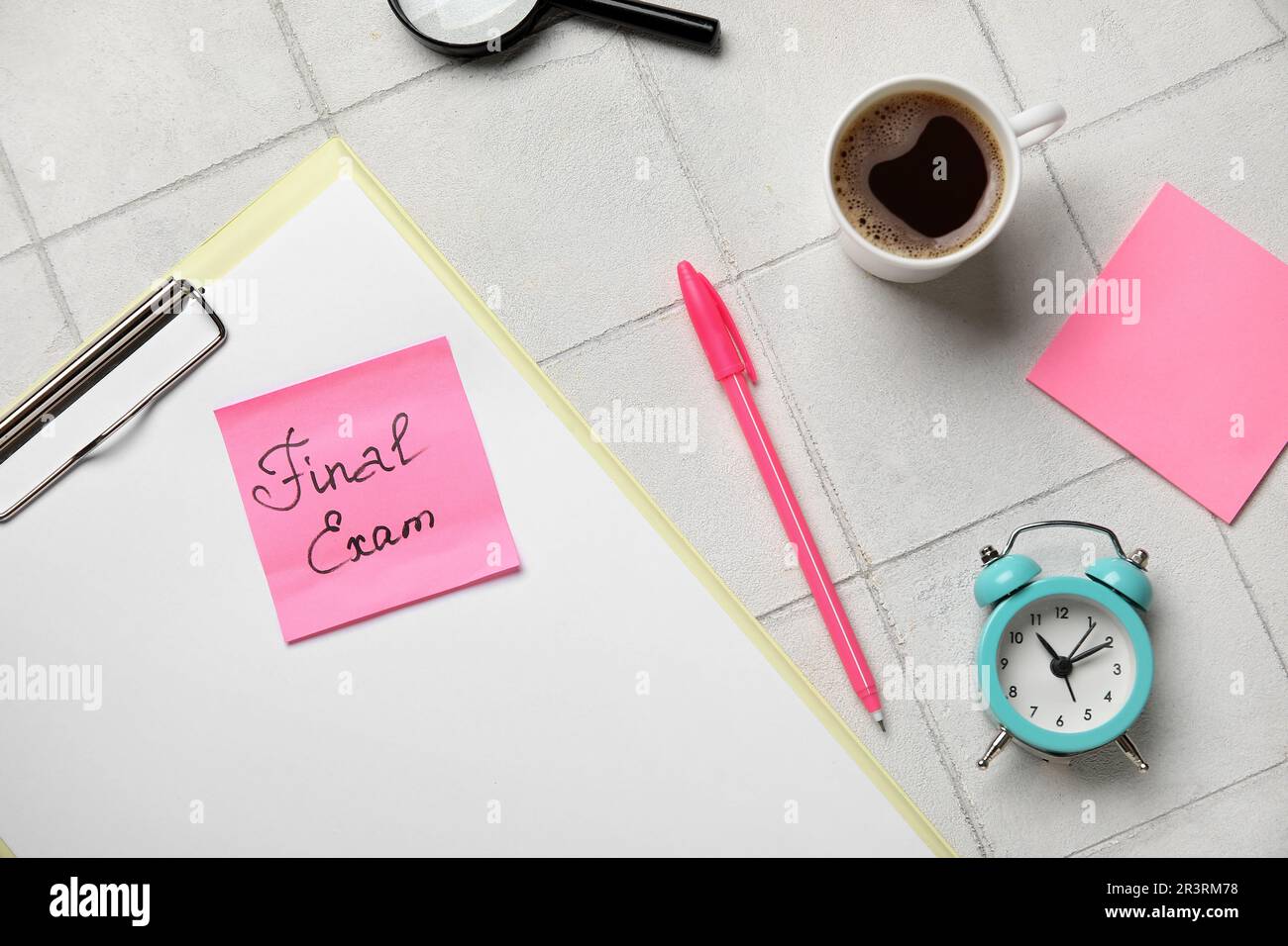 Sticky note with text FINAL EXAM, notebook, magnifier and cup of coffee ...
