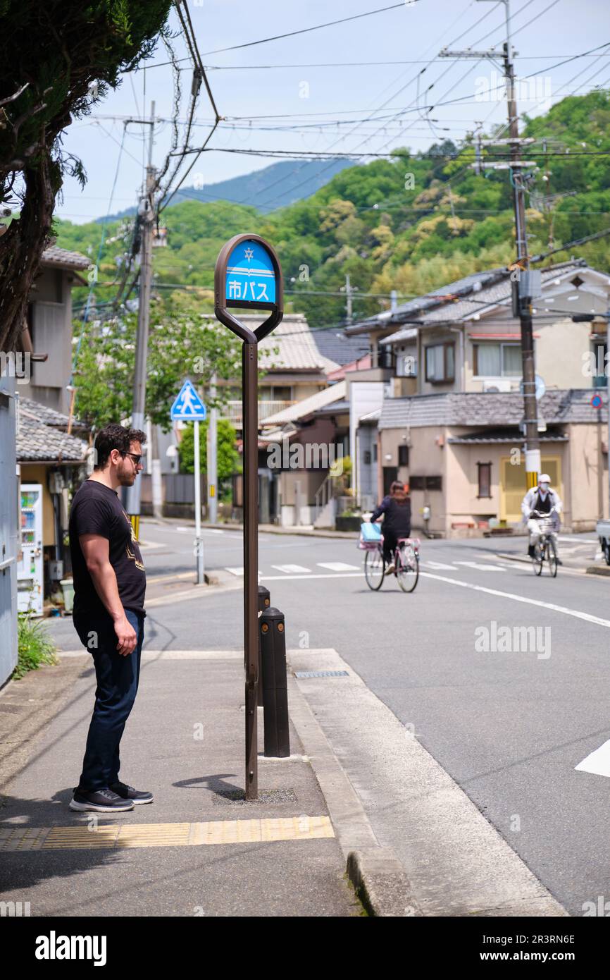 European tourist waiting city bus at bus stop near by Ginkaku-ji Temple ...