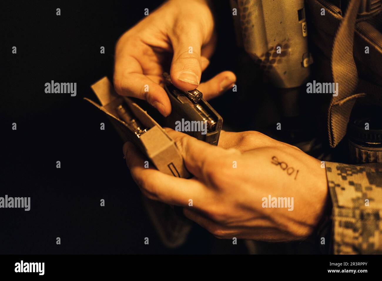 A U.S. Marine with the 26th Marine Expeditionary Unit loads a magazine ...