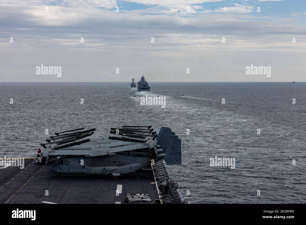 Simulated enemy boats follow the San Antonio-class amphibious transport ...