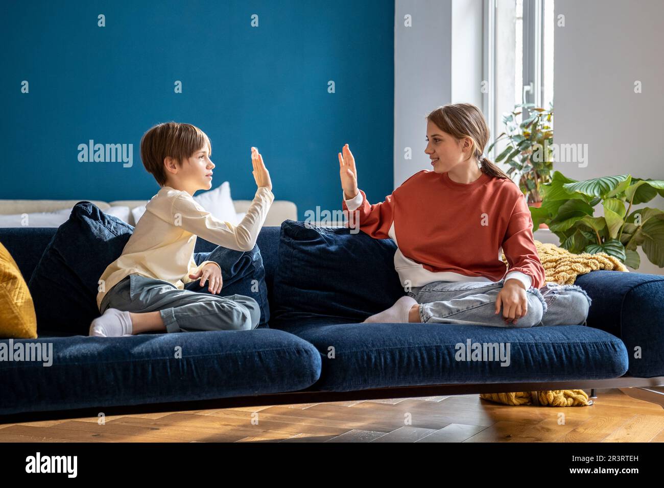 Happy children siblings giving high five to each other, brother and ...