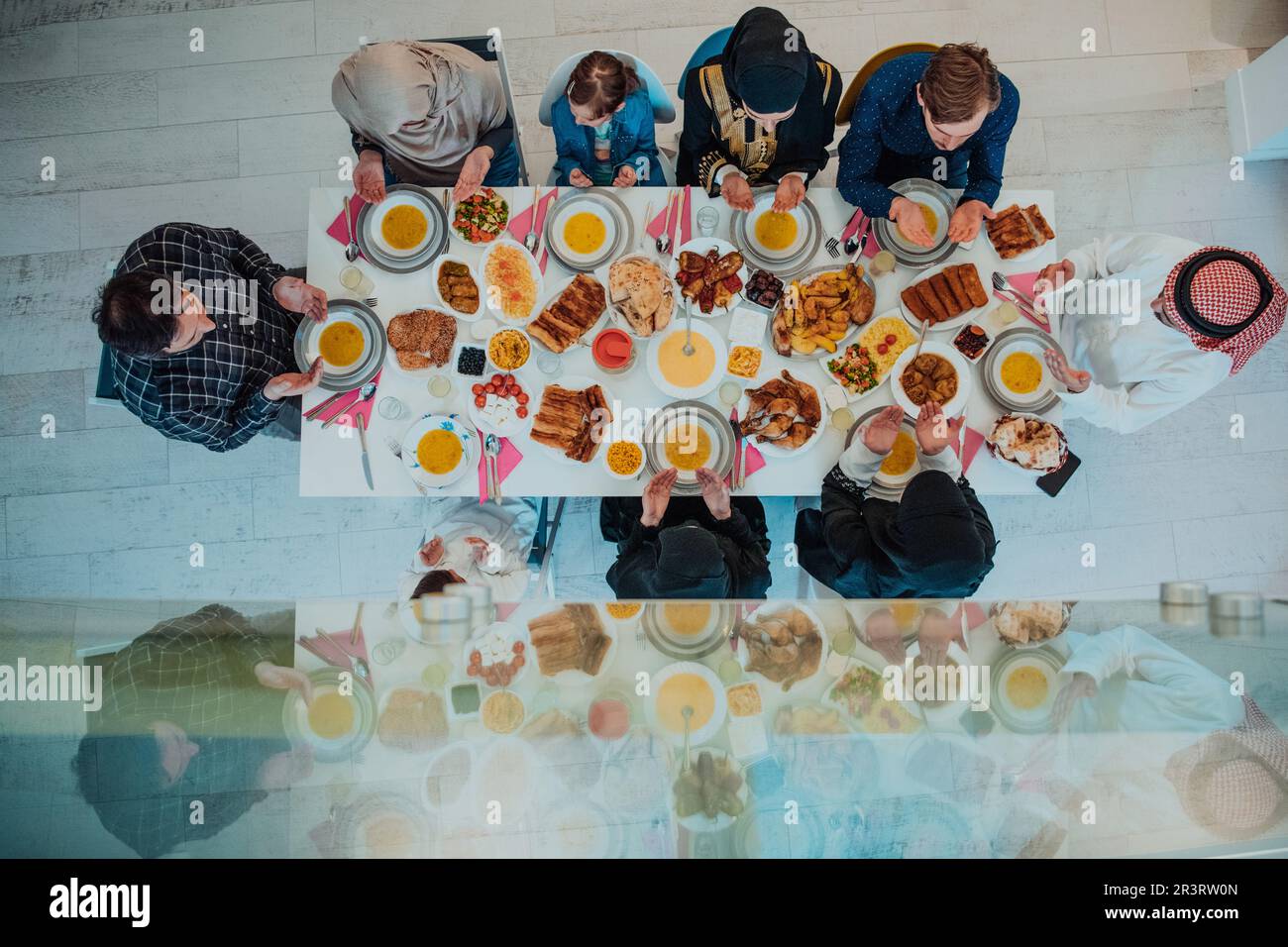 Top view of Muslim family having Iftar dinner drinking water to break ...