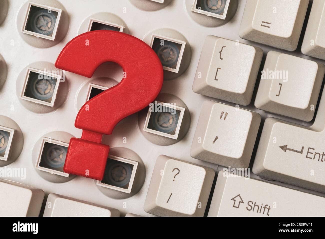 Close-up of a disassembled computer keyboard with a red question mark ...