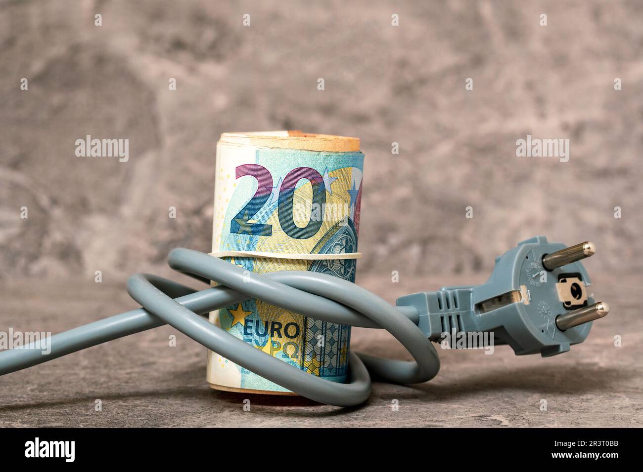 Electric plug and roll of euro currency Stock Photo - Alamy