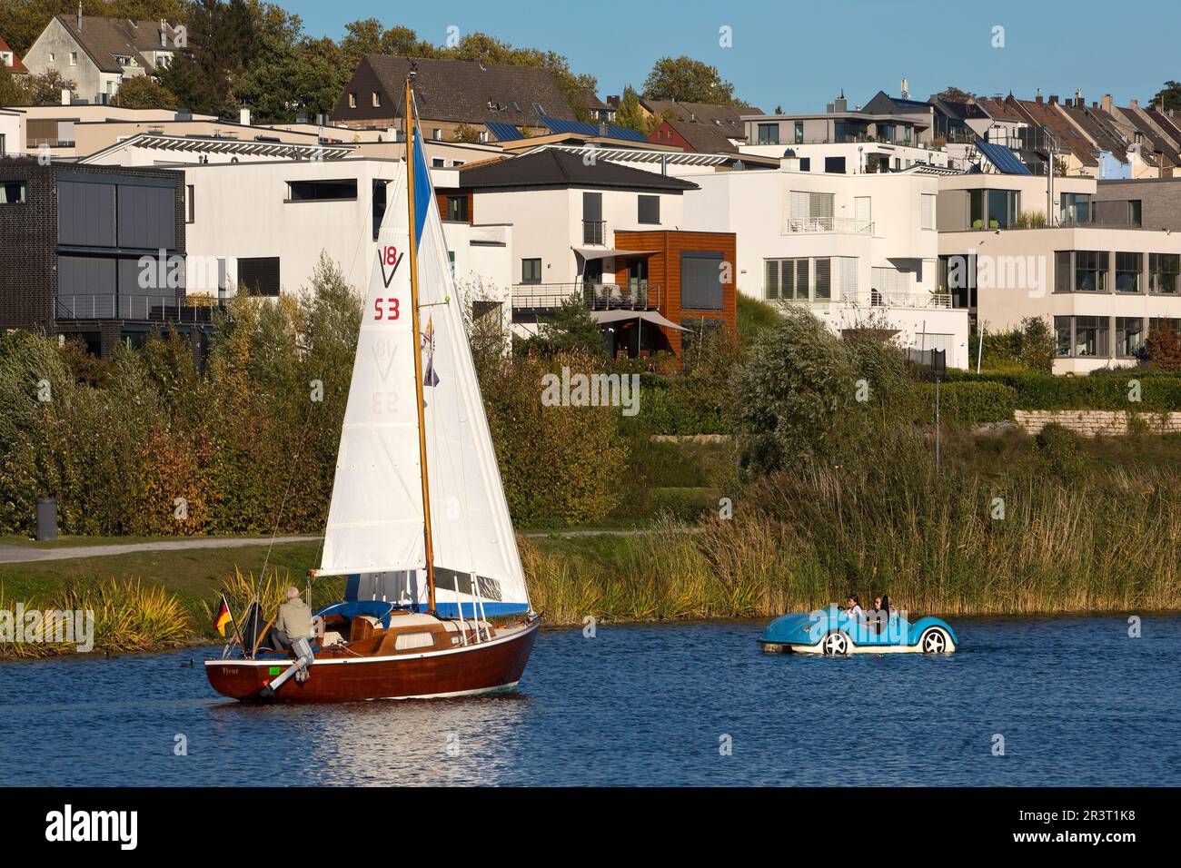 A sailboat and a trees on the Phoenix See in Dortmund, North Rhine ...