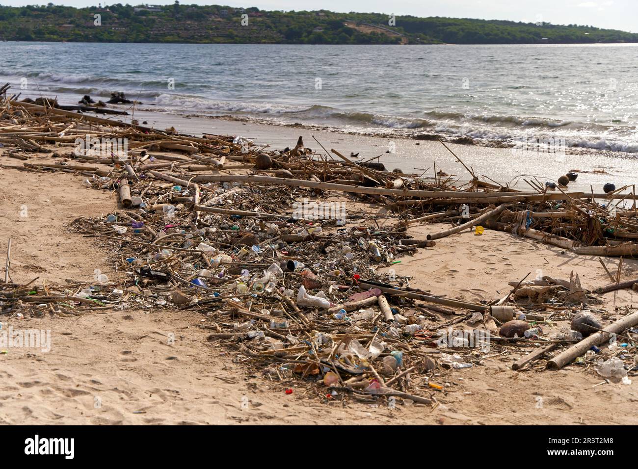Mountains of waste and garbage on the sandy beach after the tide ...