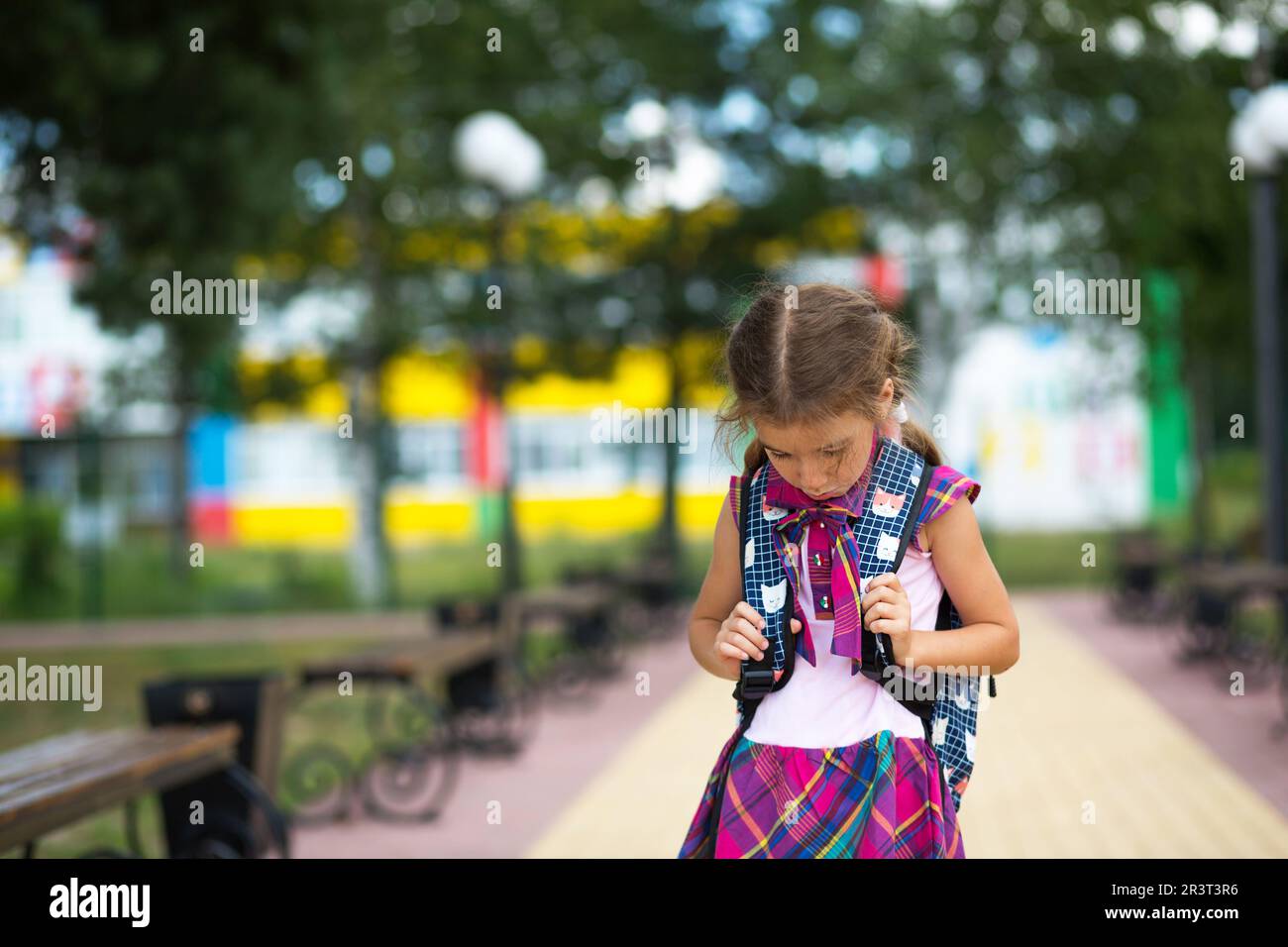 Sad, upset girl near the school with a backpack. Fatigue from classes ...