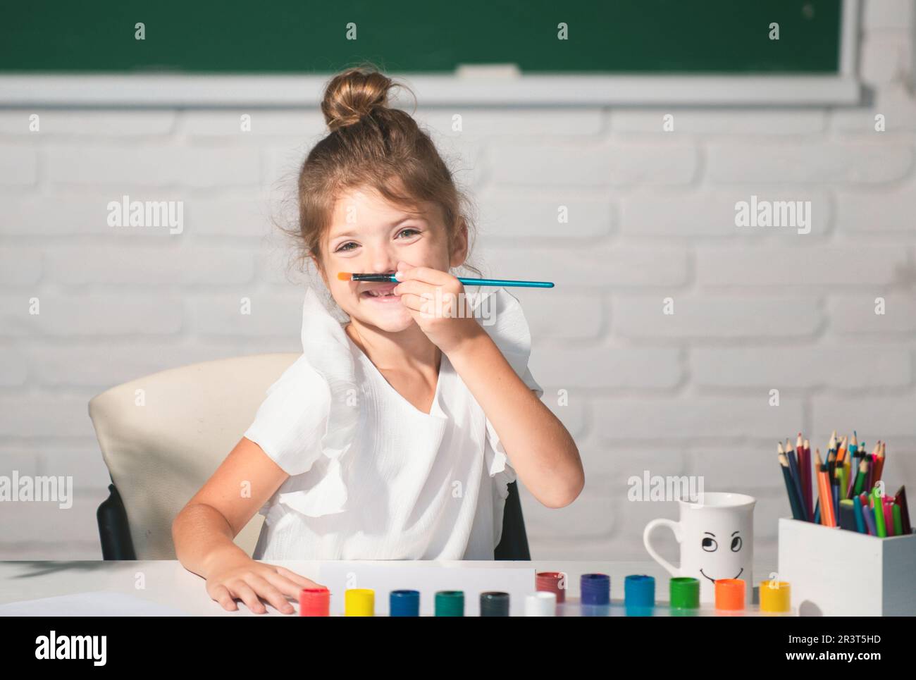 Child girl drawing with coloring pens paintind. Portrait of adorable ...