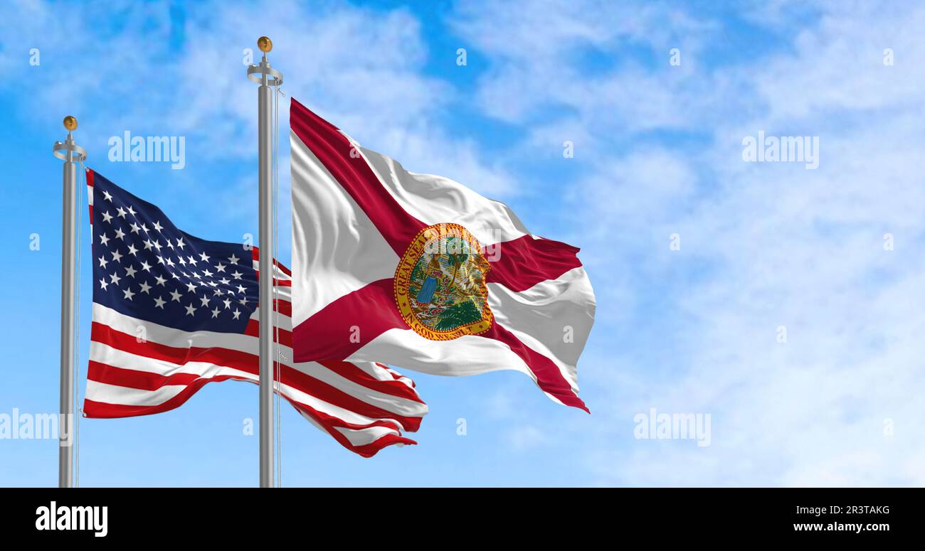 The Florida state flag waving along with the national flag of the ...