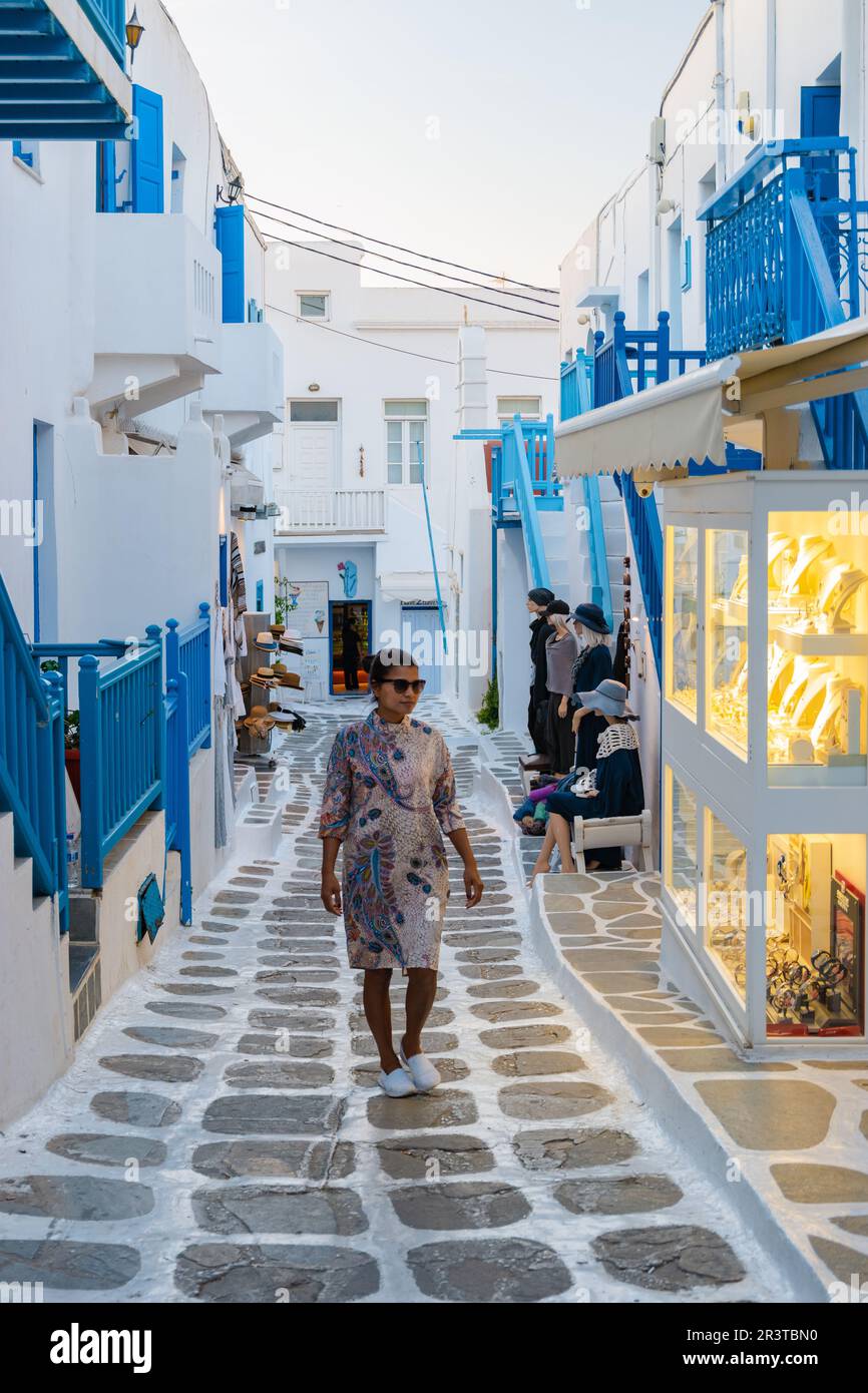 Tourist at the streets of Mykonos Greek village in Greece, colorful ...