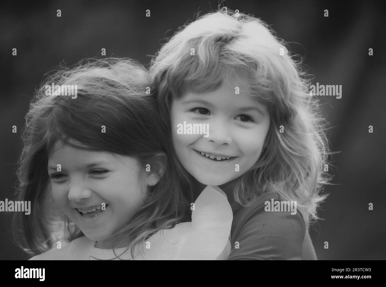 Hugging and kissing kids couple. Little lovely children outdoor. Happy ...