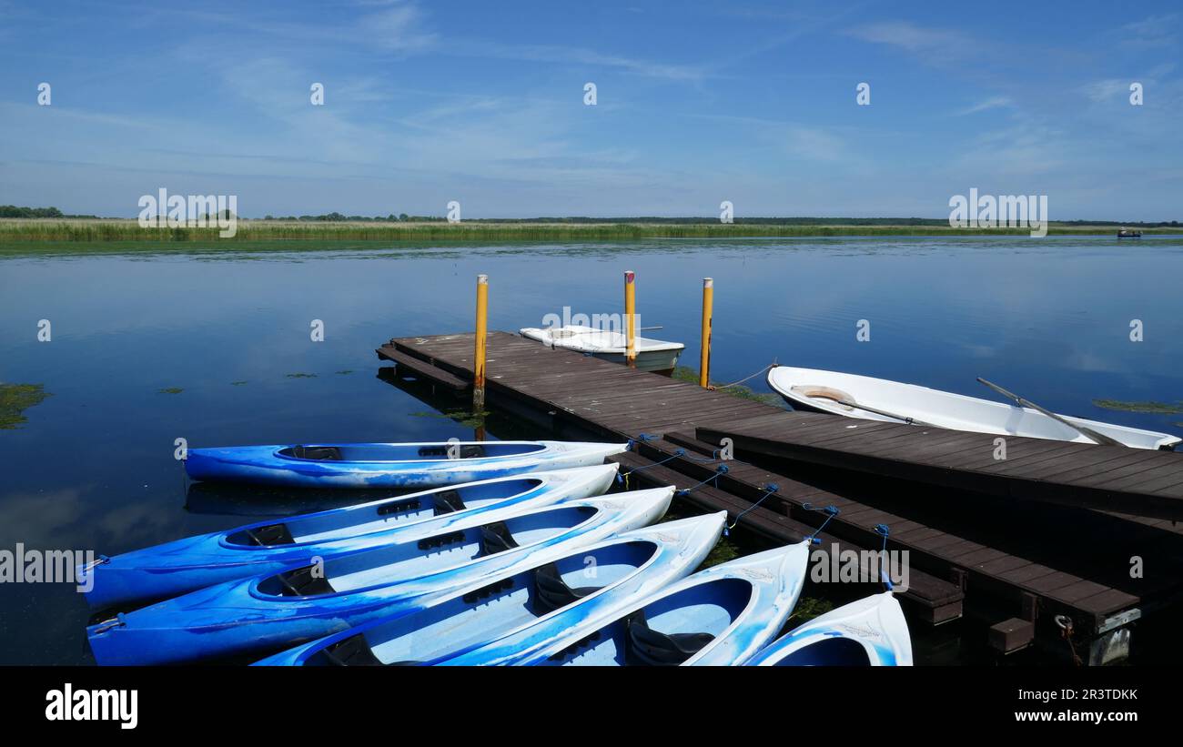 River landscape with kayaks at the jetty Stock Photo - Alamy