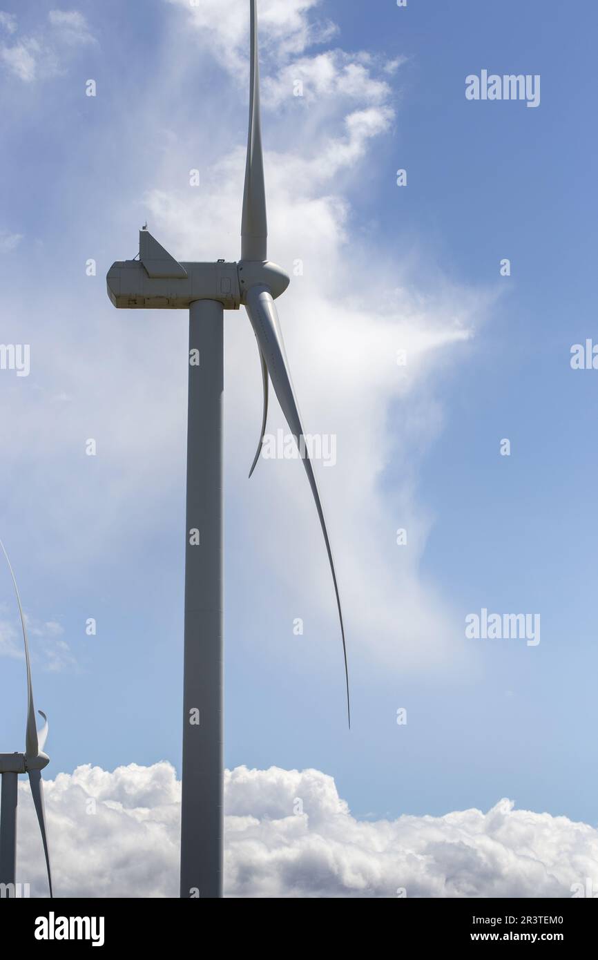 Windmill close-up of a blue sky with white fluffy clouds. Green energy ...
