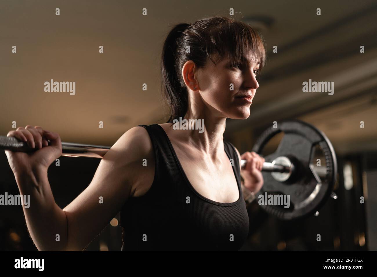 Fitness woman doing exercise with heavy weight bar in the gym. Female ...