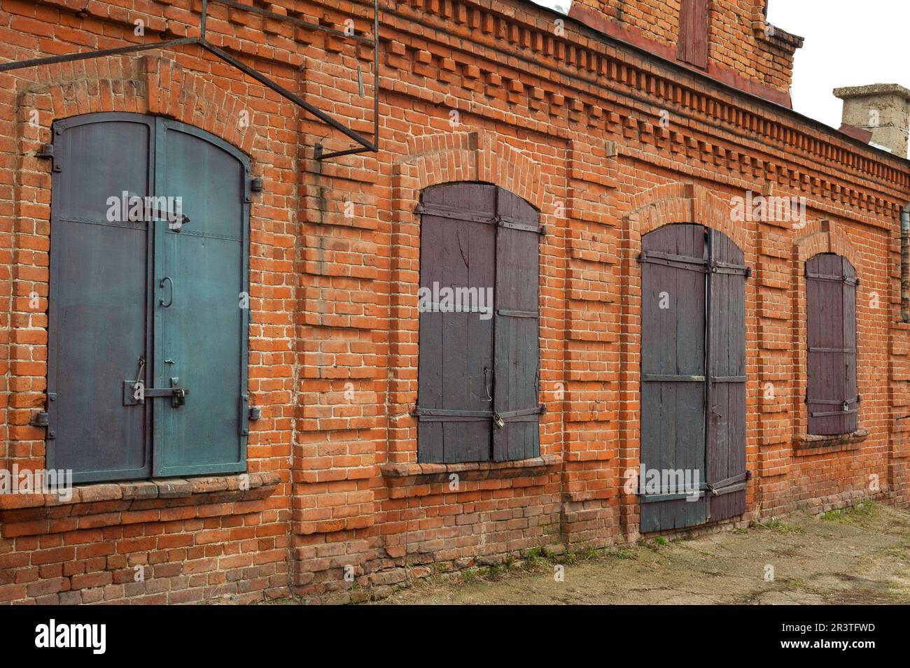 Historical old closed metal windows shutter in brick wall Stock Photo ...