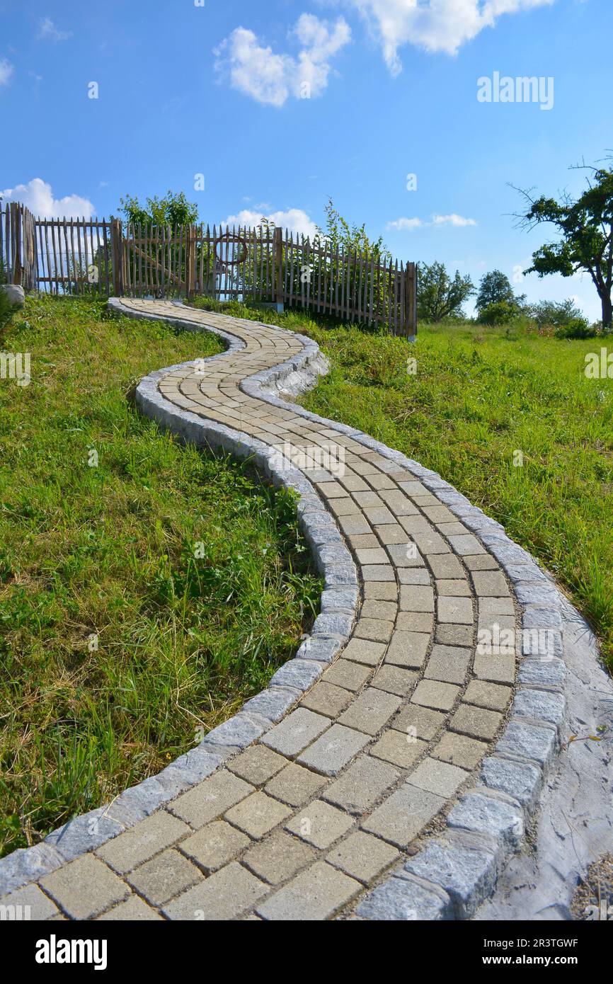 Beautifully curved cobblestone path to the garden Stock Photo - Alamy