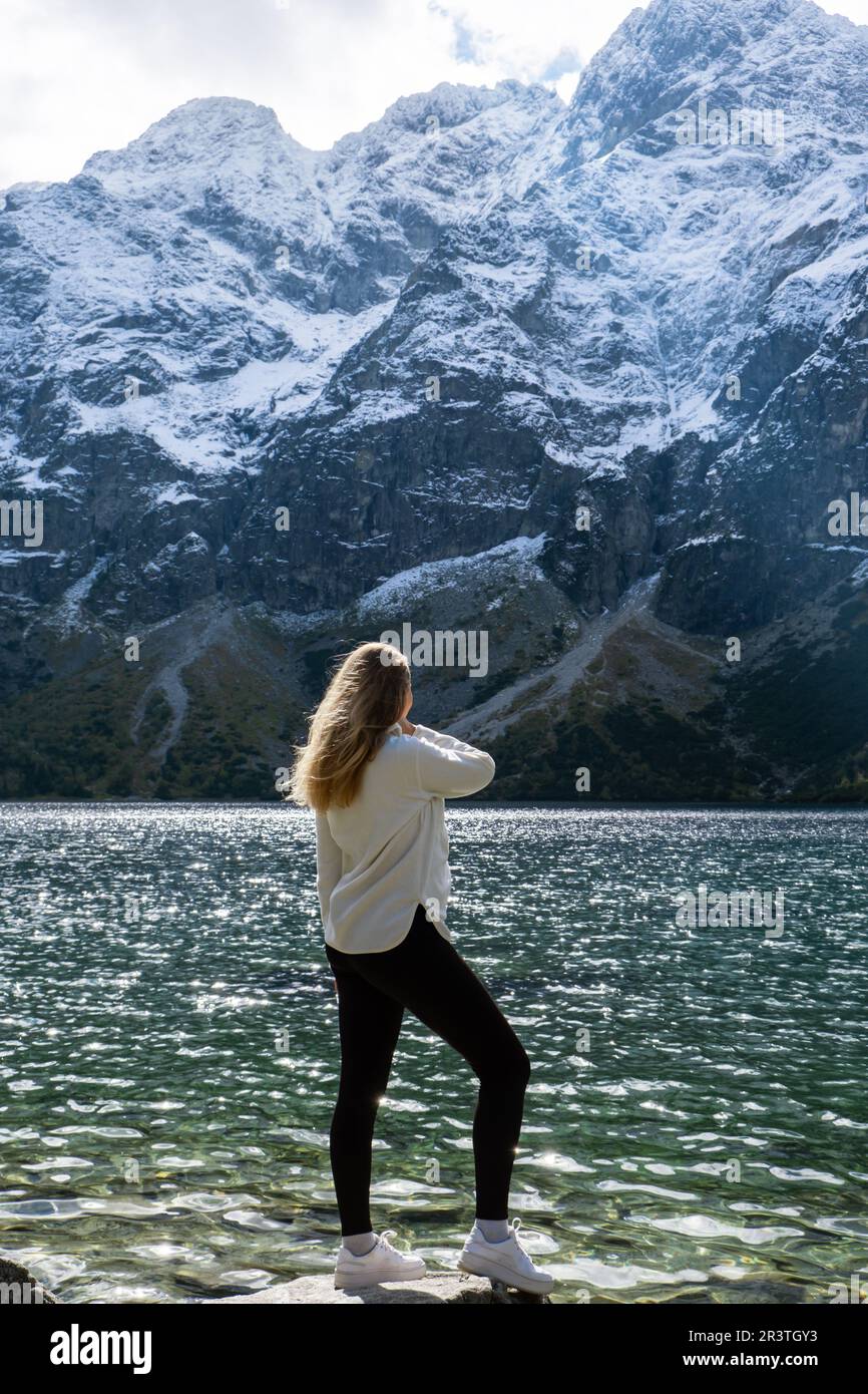Young woman enjoying nature in Morskie Oko Snowy Mountain Hut in Polish ...