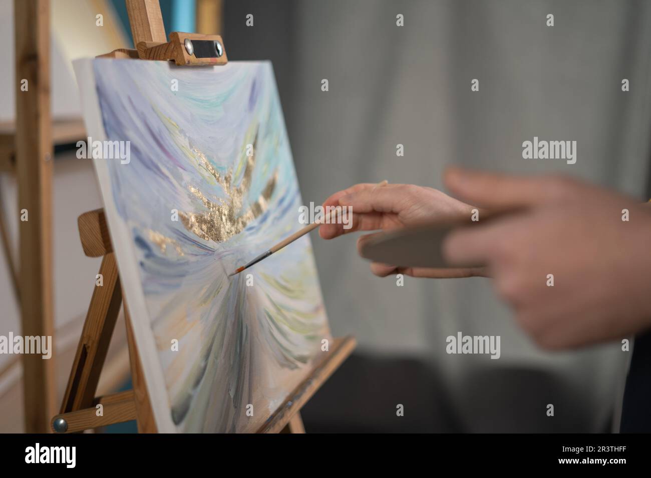 Hands of artist with brush and palette painting picture in studio. Art ...