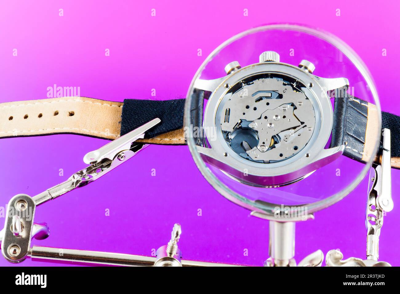 Elegant watch repaired using a magnifier with three handles Stock Photo ...