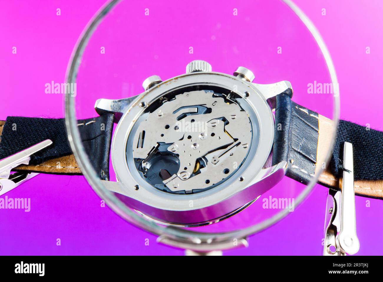 Elegant watch repaired using a magnifier with three handles Stock Photo ...