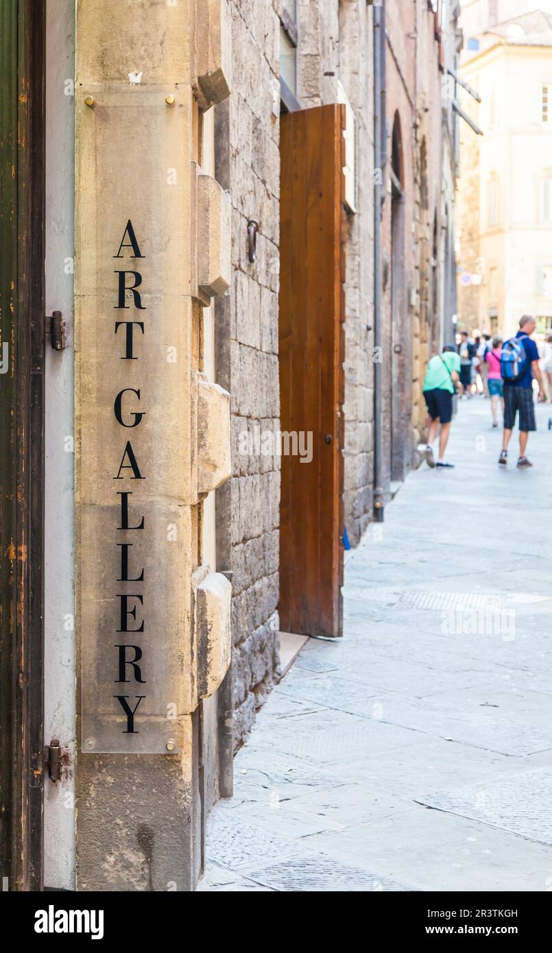 Tuscany, Italy. An art gallery signseen in a street full of turism ...