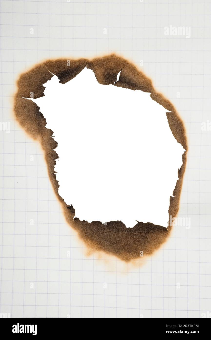 Paper with burnt hole Stock Photo - Alamy