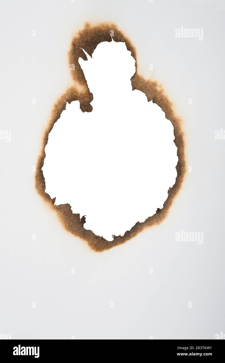 Paper with burnt hole Stock Photo - Alamy