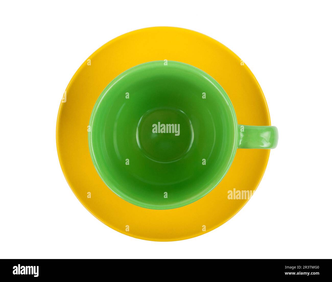 Green round empty tea cup on a yellow saucer Stock Photo - Alamy