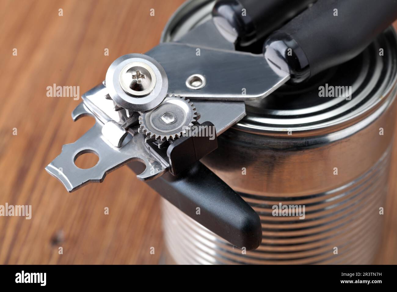 Tin opener opening a can Stock Photo - Alamy