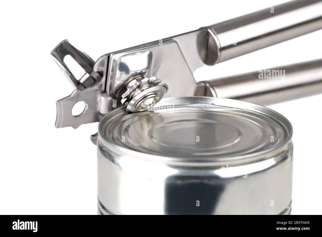 Tin opener opening a can Stock Photo - Alamy