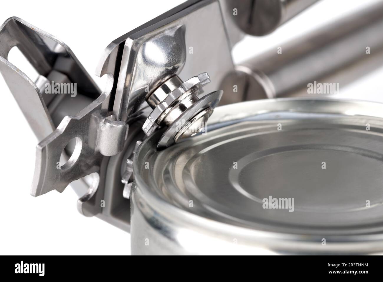 Tin opener opening a can of food isolated on white Stock Photo - Alamy