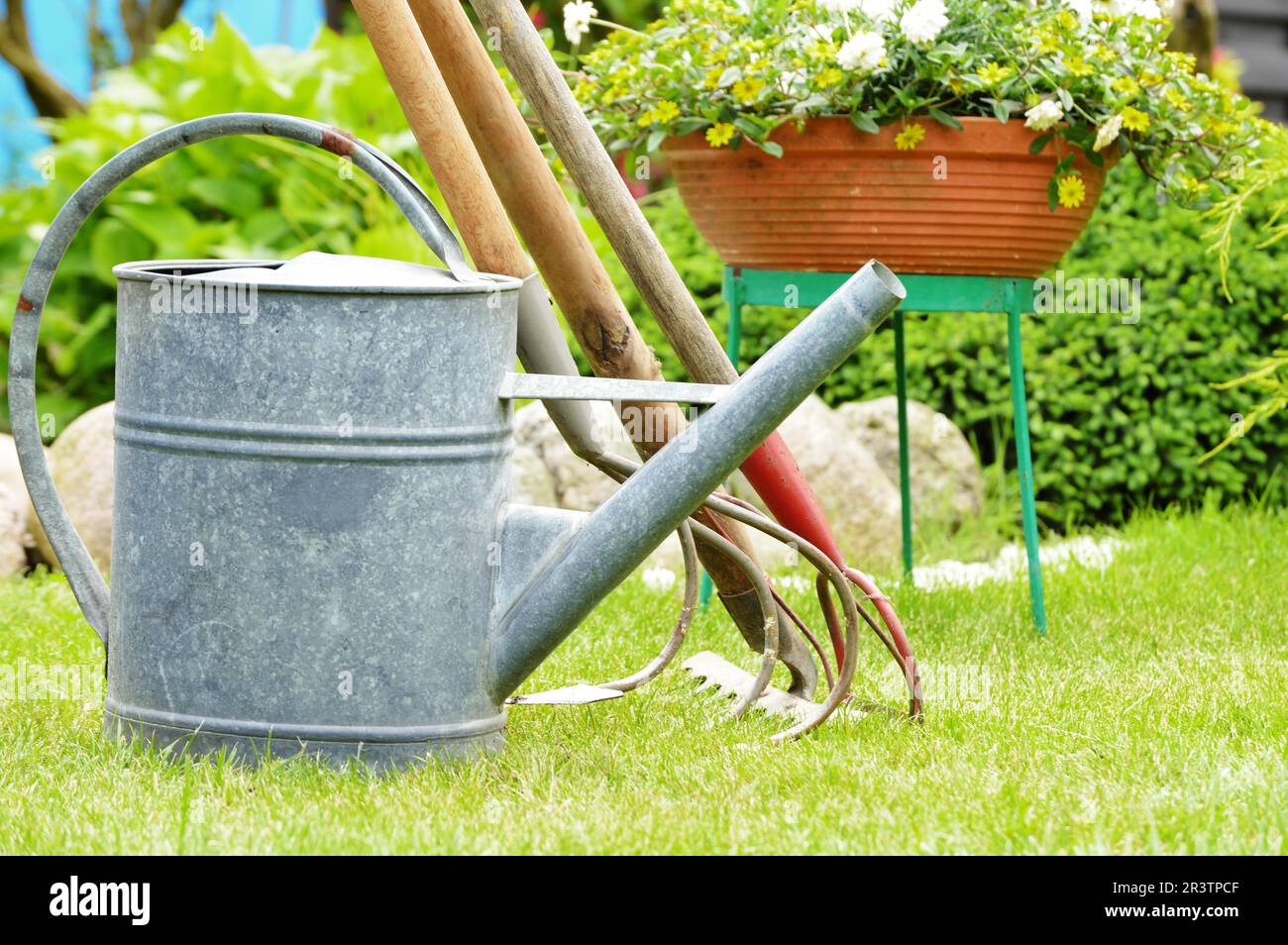 Watering can and garden tools Stock Photo - Alamy