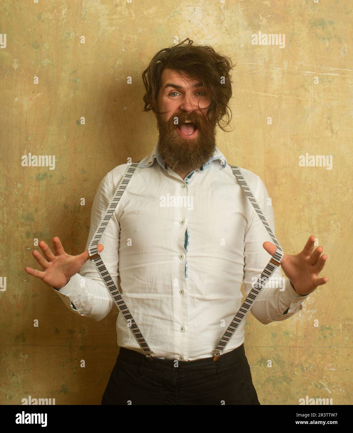 Portrait of funny shaggy crazy guy pull his suspenders feel candid face ...