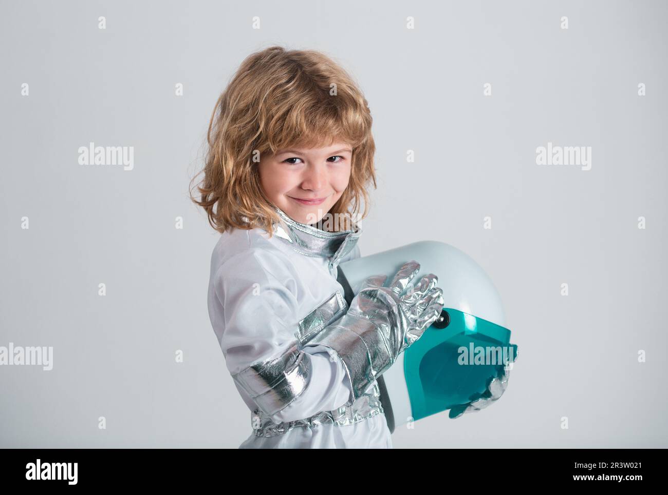Cute little boy spaceman child in space suit holding helmet isolated on ...