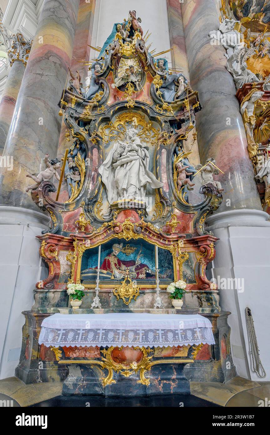 Side altar with floral decoration and saint's relic St. Benedict ...