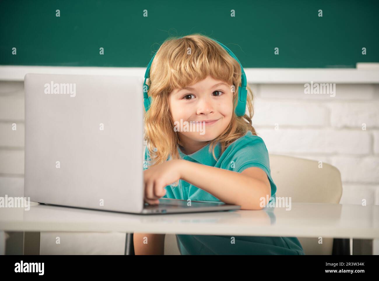 Cute funny child using laptop computer, kid boy studying through online ...