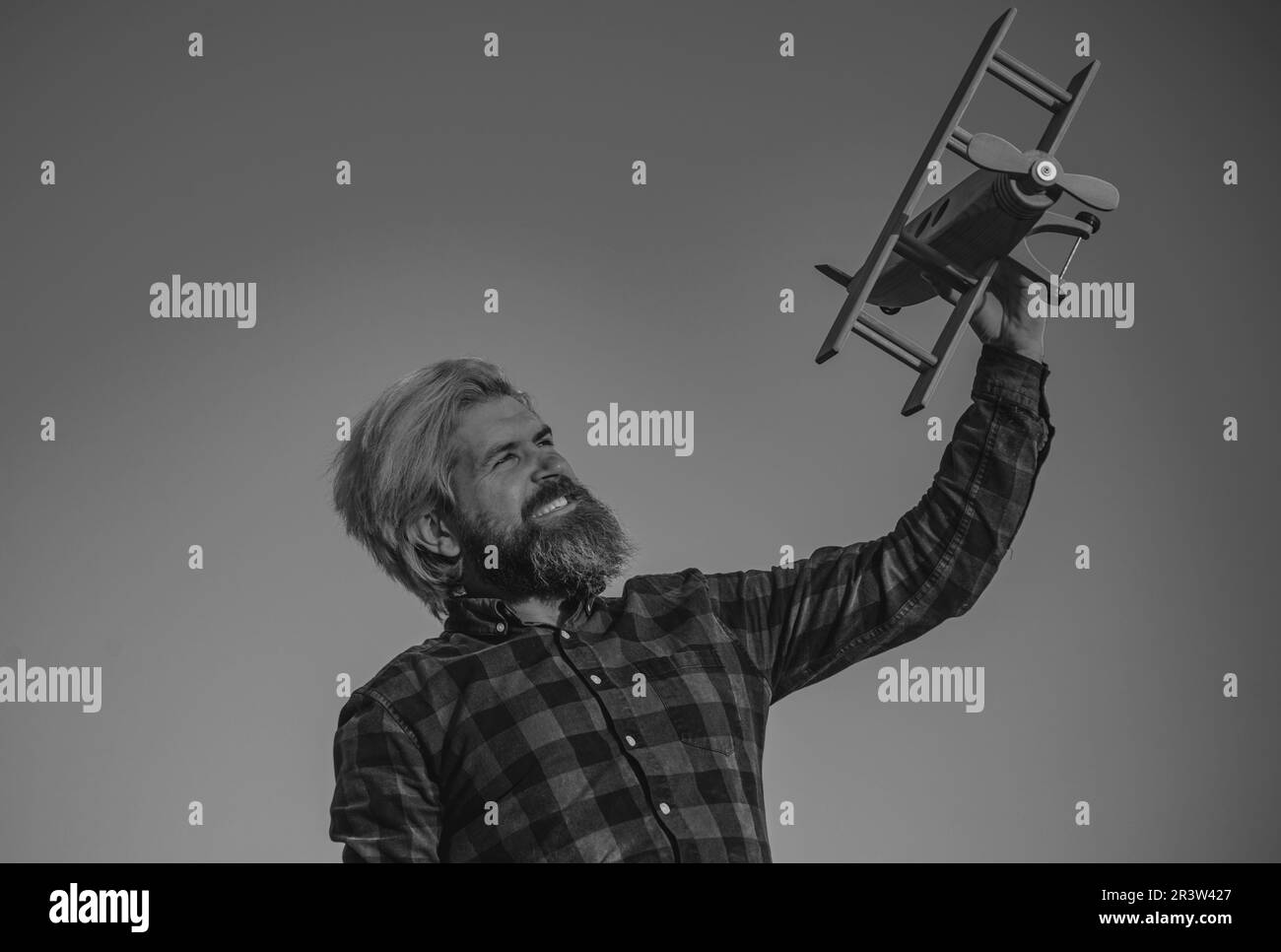 Happy expression. Happy bearded man play with toy plane. Funny crazy ...