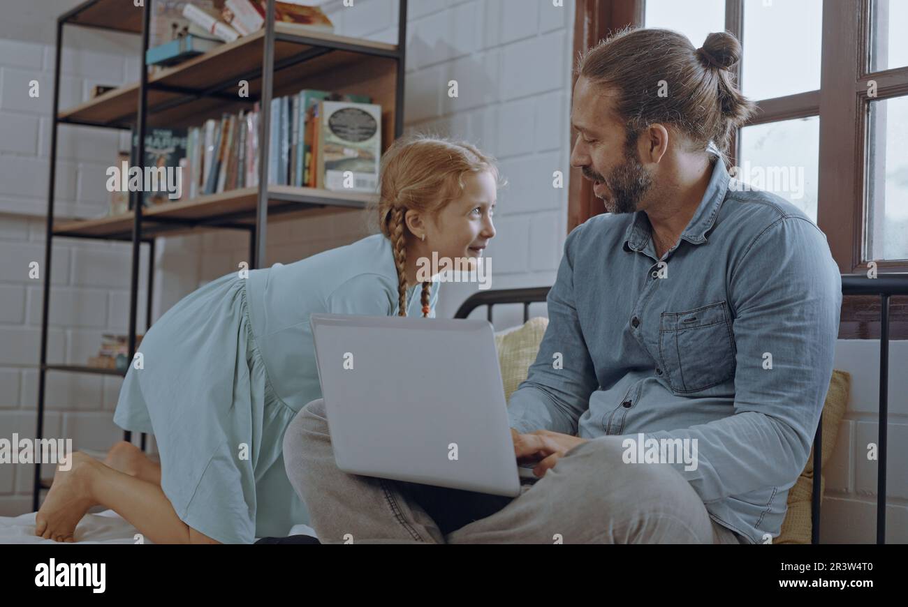 Father using laptop computer with young daughter. Happy family, Father ...
