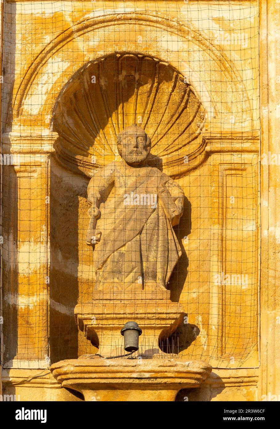 Stonework sculpture of Saint Peter in niche on front of cathedral ...