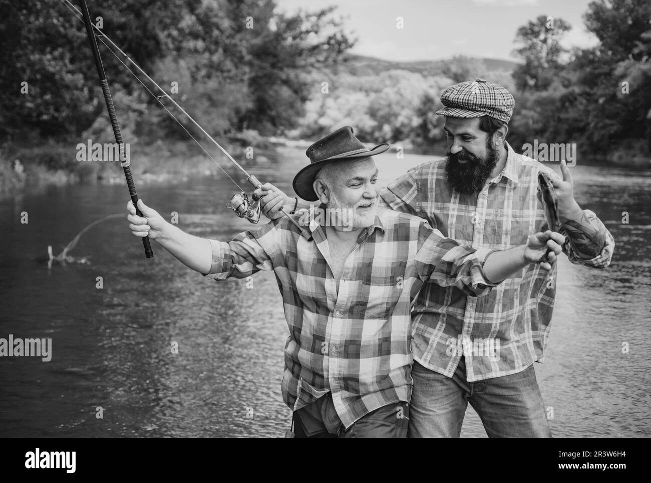 Two men friends fishing. Flyfishing angler makes cast, standing in ...
